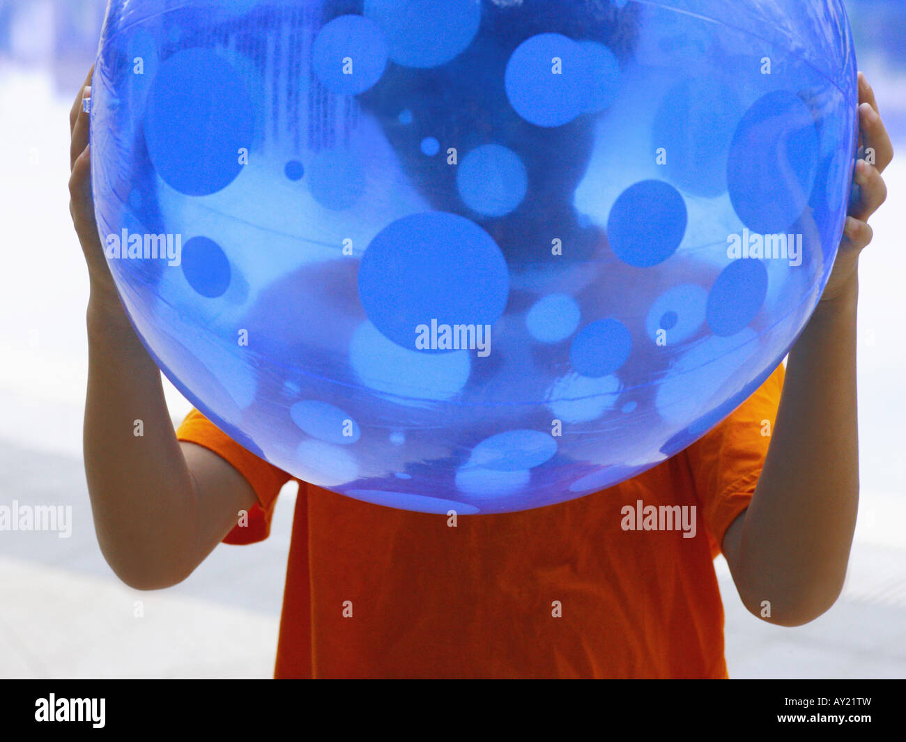 Close-up of a boy holding a ball in front of his face Stock Photo - Alamy