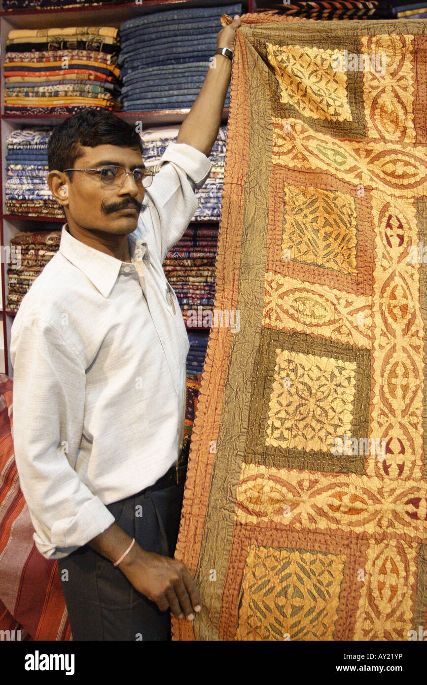 A man shows fabric produced in a factory in Jaipur, Rajasthan. It is ...