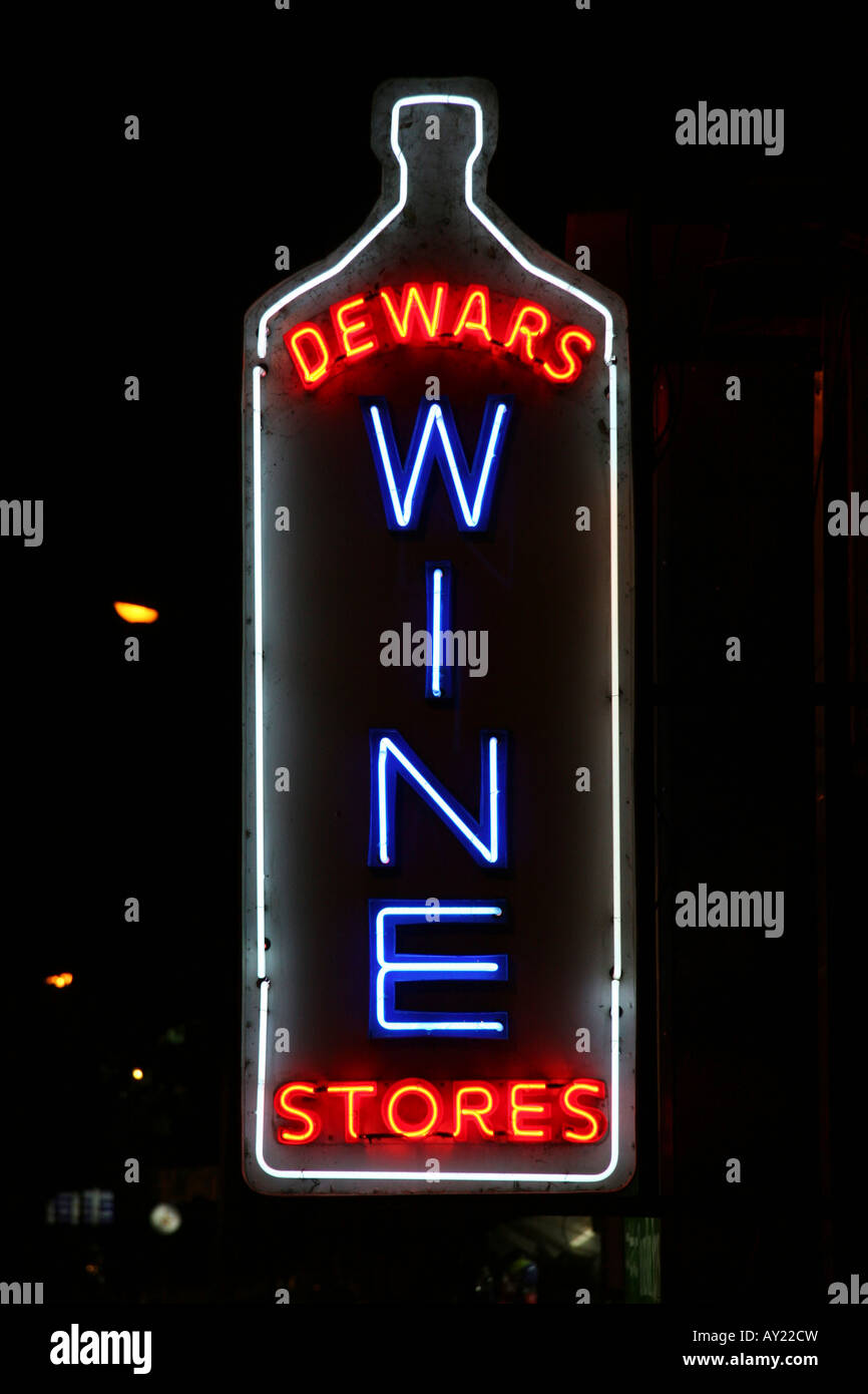 A bottle shaped neon light sign advertises a wine store in Bangalore ...