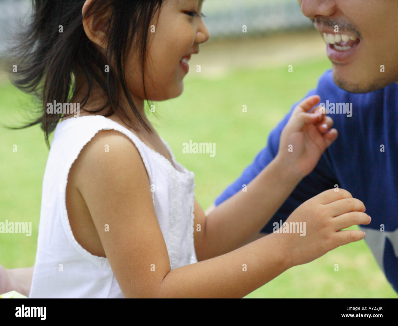 Side profile of a girl and her father smiling Stock Photo - Alamy