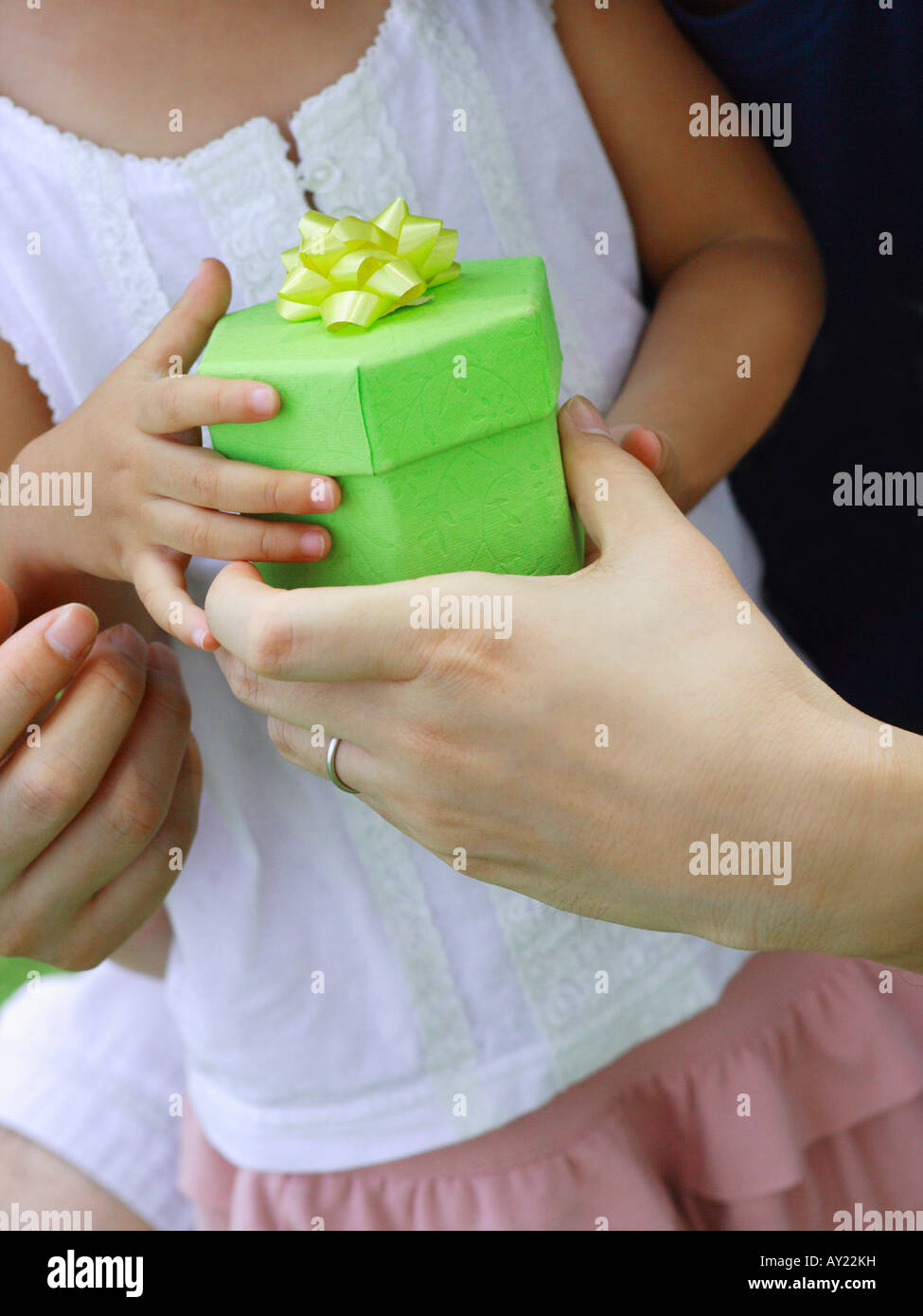 Mid section view of a girl taking a gift from a person's hand Stock ...