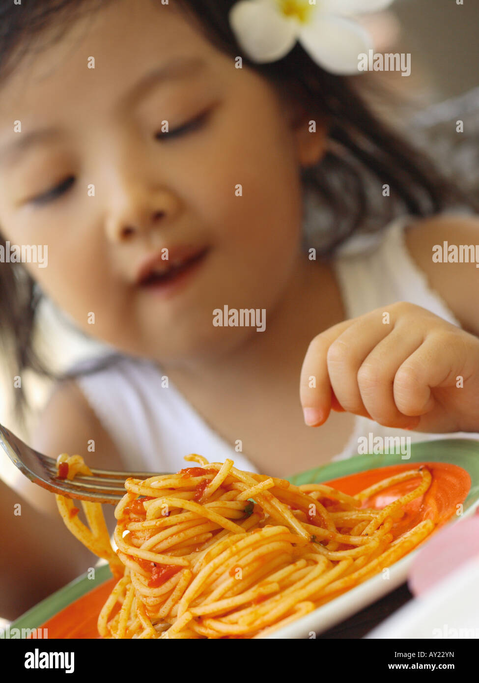 Close-up of a girl eating noodles Stock Photo - Alamy