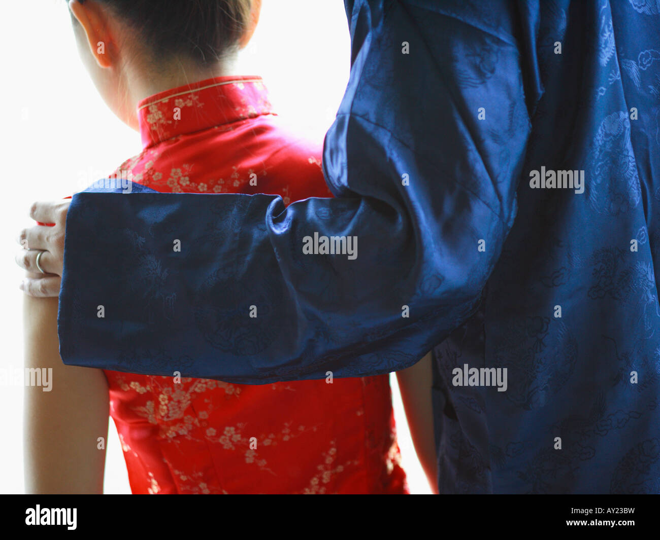 Rear view of a man's hand on a woman's shoulder Stock Photo - Alamy