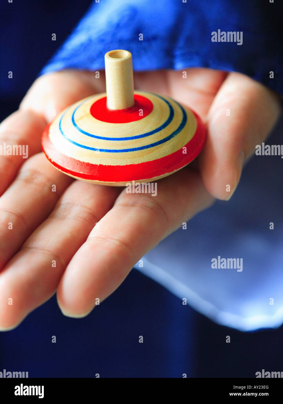 Close-up of a top on a person's palm Stock Photo - Alamy