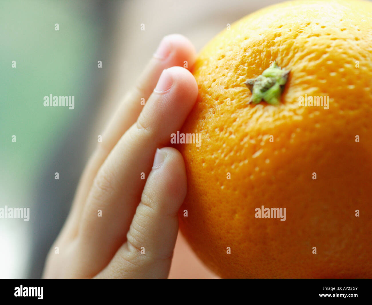 Close-up of a child's finger touching an orange Stock Photo - Alamy
