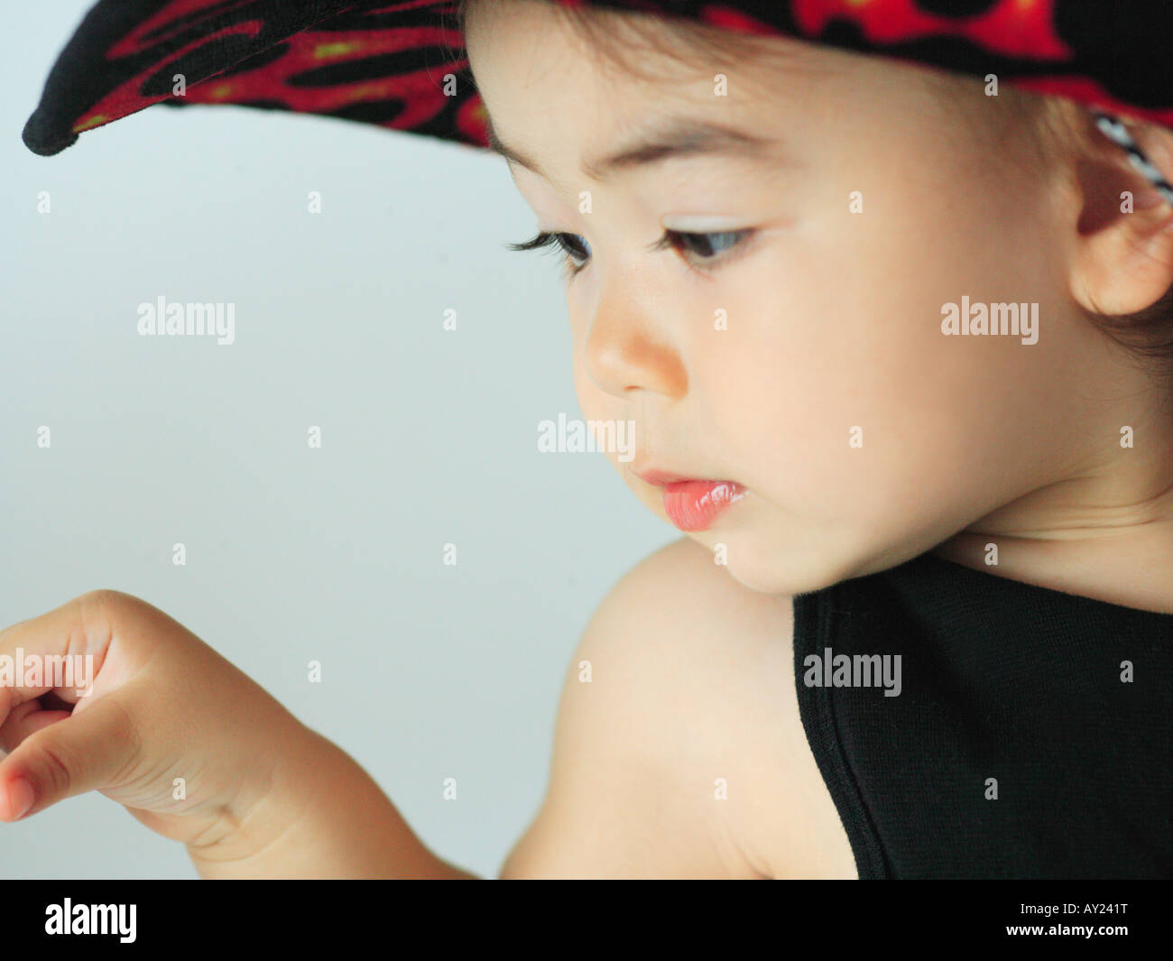 Close-up of a baby girl looking down Stock Photo - Alamy