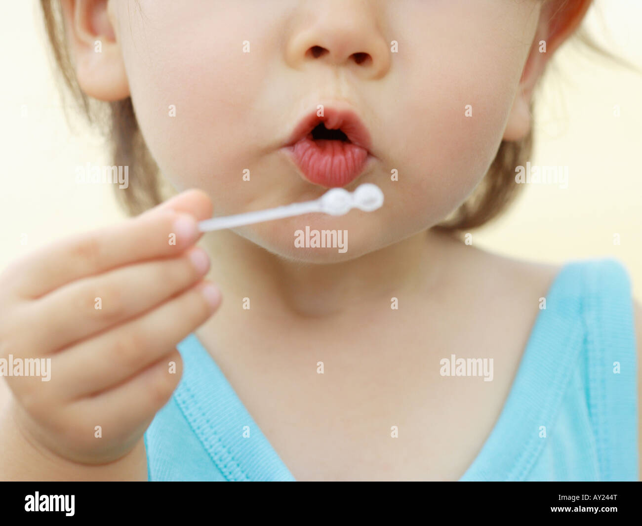 Close-up of a baby girl blowing bubbles with a bubble wand Stock Photo ...