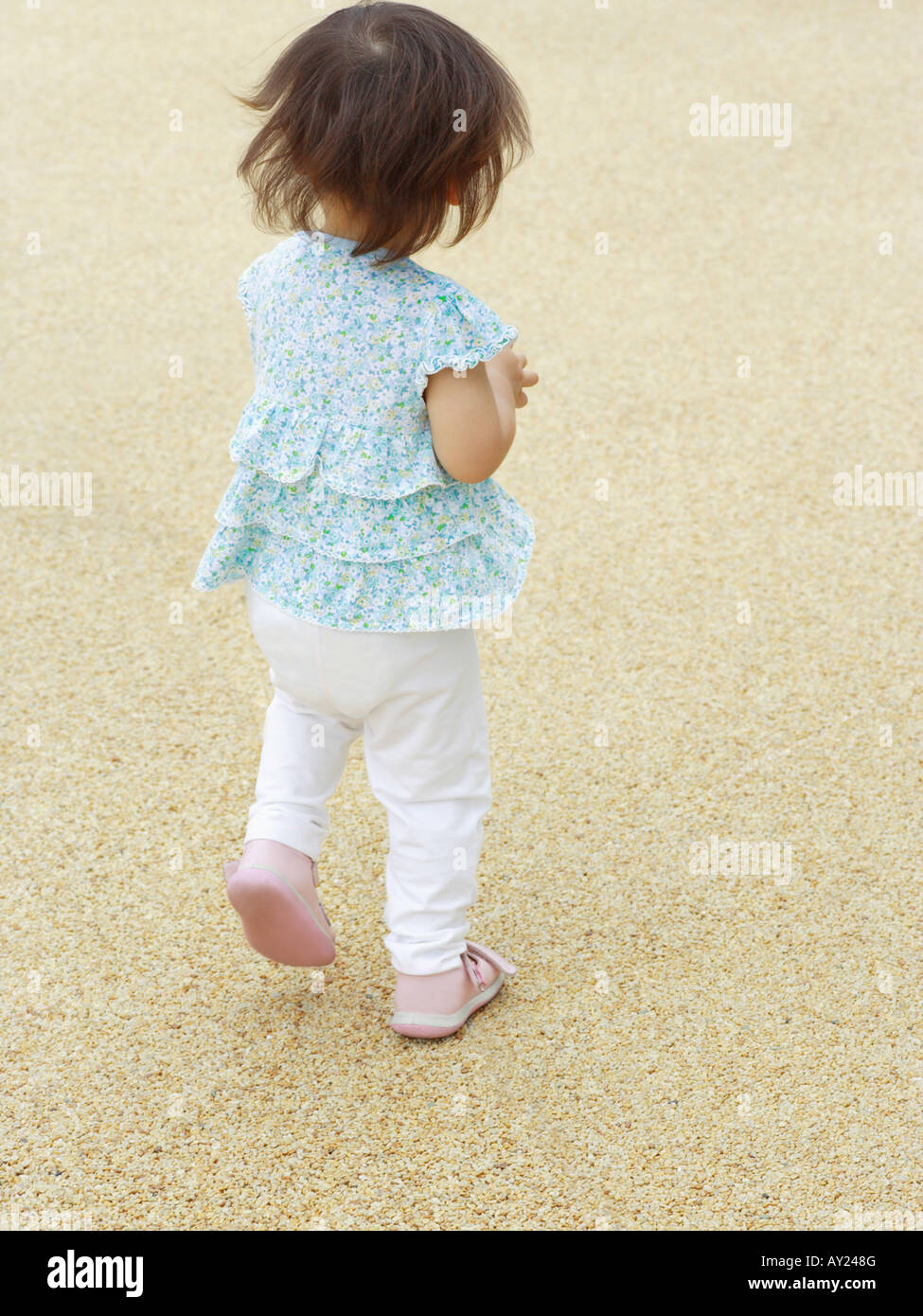 Rear view of a baby girl walking Stock Photo - Alamy