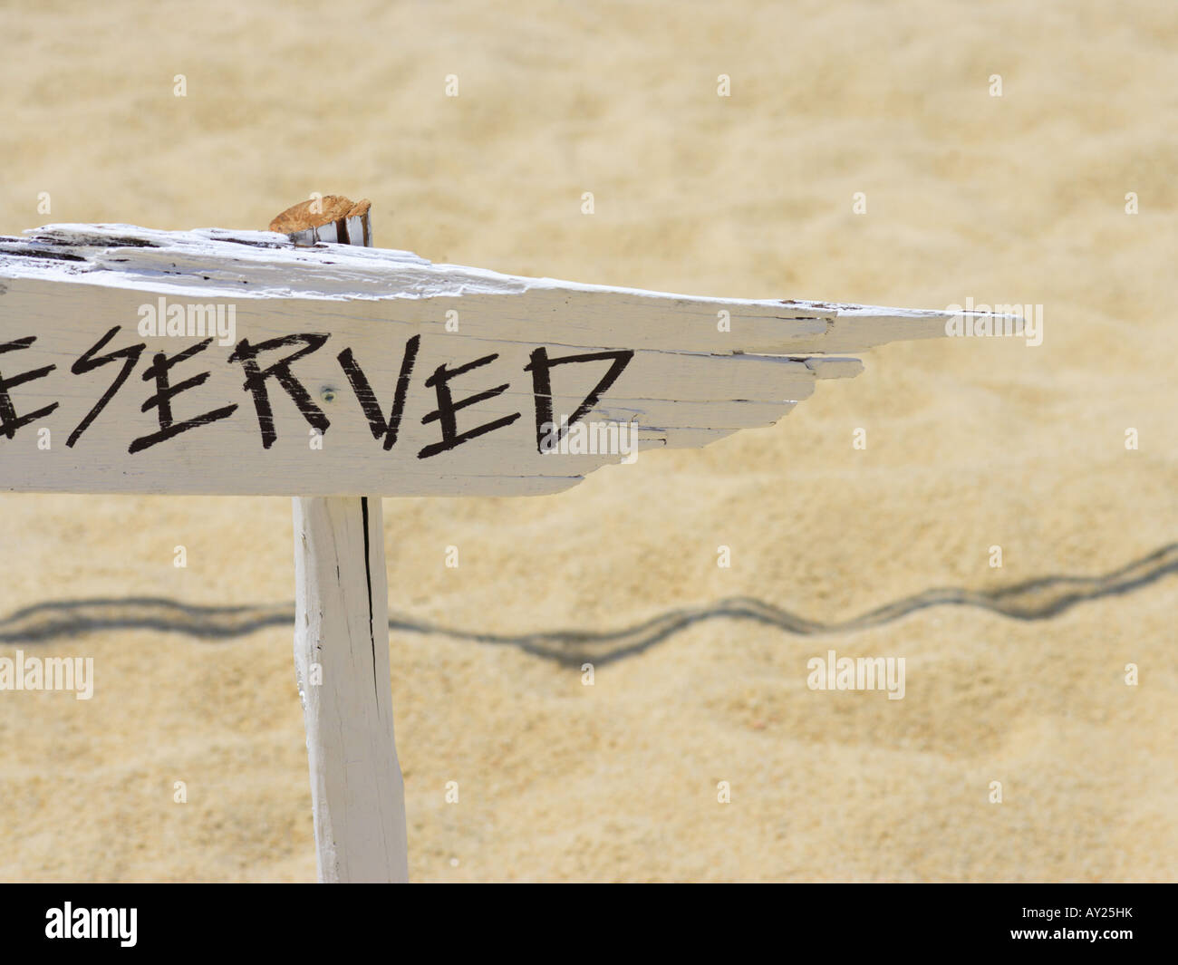 Close-up of a reserved signboard in sand Stock Photo - Alamy