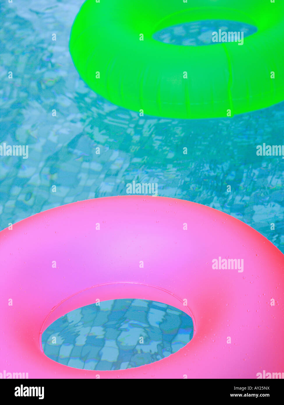 High angle view of two inflatable rings floating in a swimming pool ...
