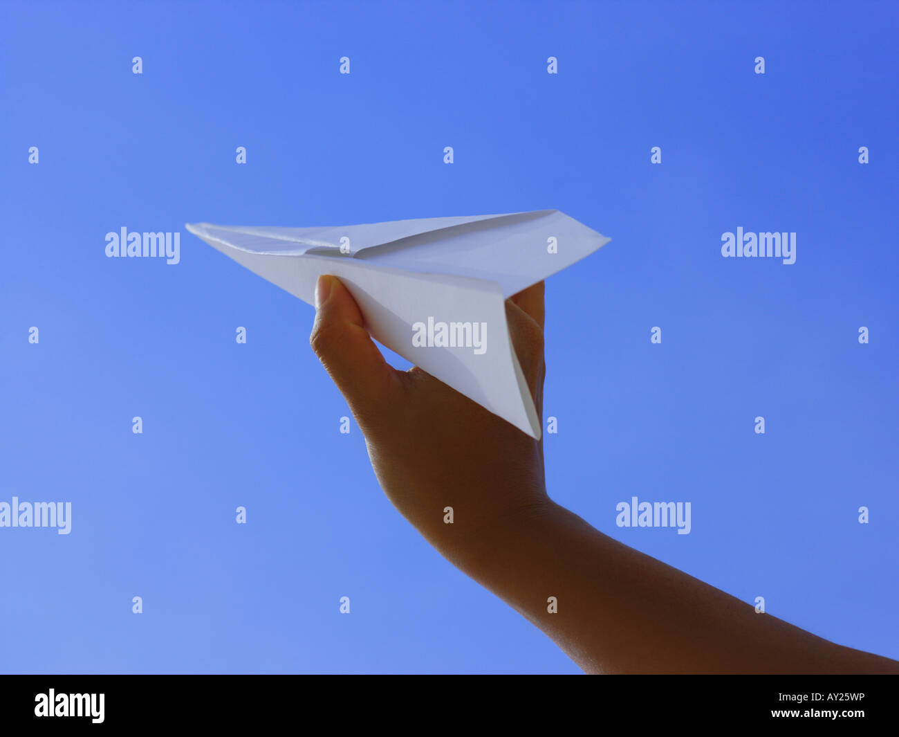 Close-up of a person's hand holding a paper airplane Stock Photo - Alamy