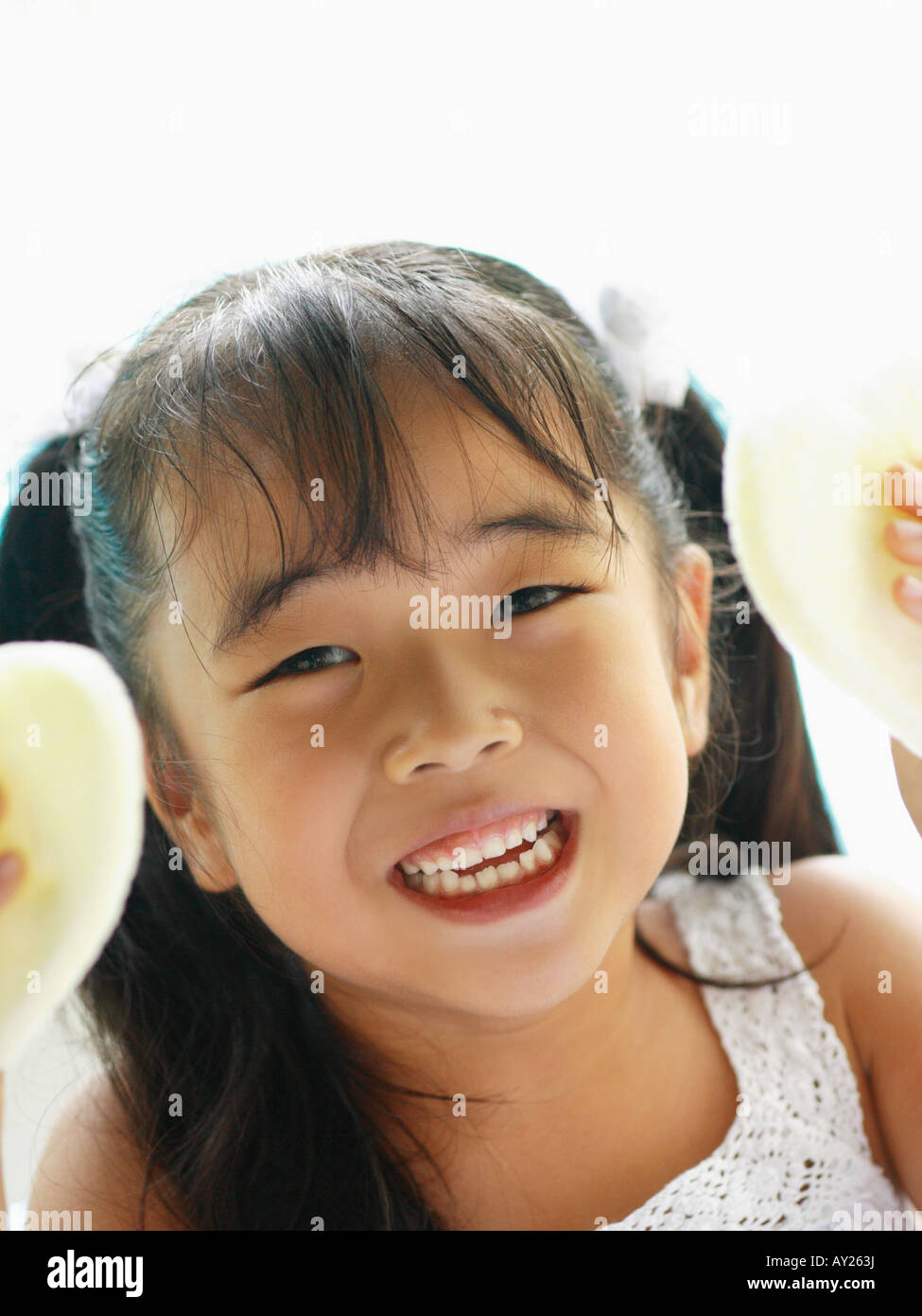 Portrait of a girl holding two heart shaped breads and smiling Stock ...