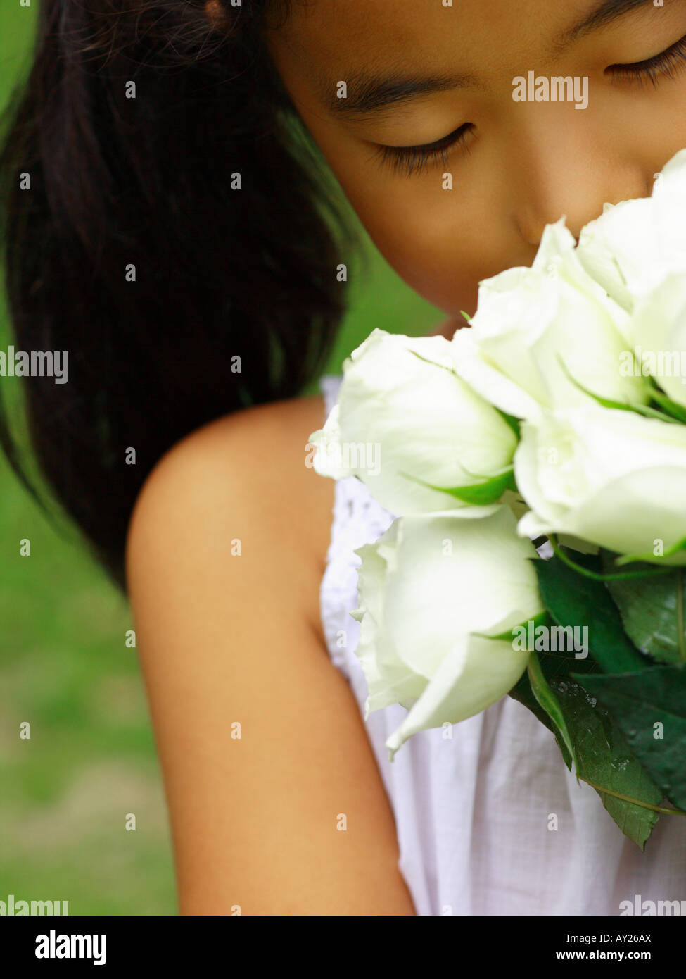 Close-up of a girl smelling white roses Stock Photo - Alamy