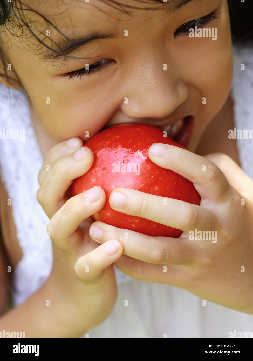 Close-up of a girl biting an apple Stock Photo - Alamy