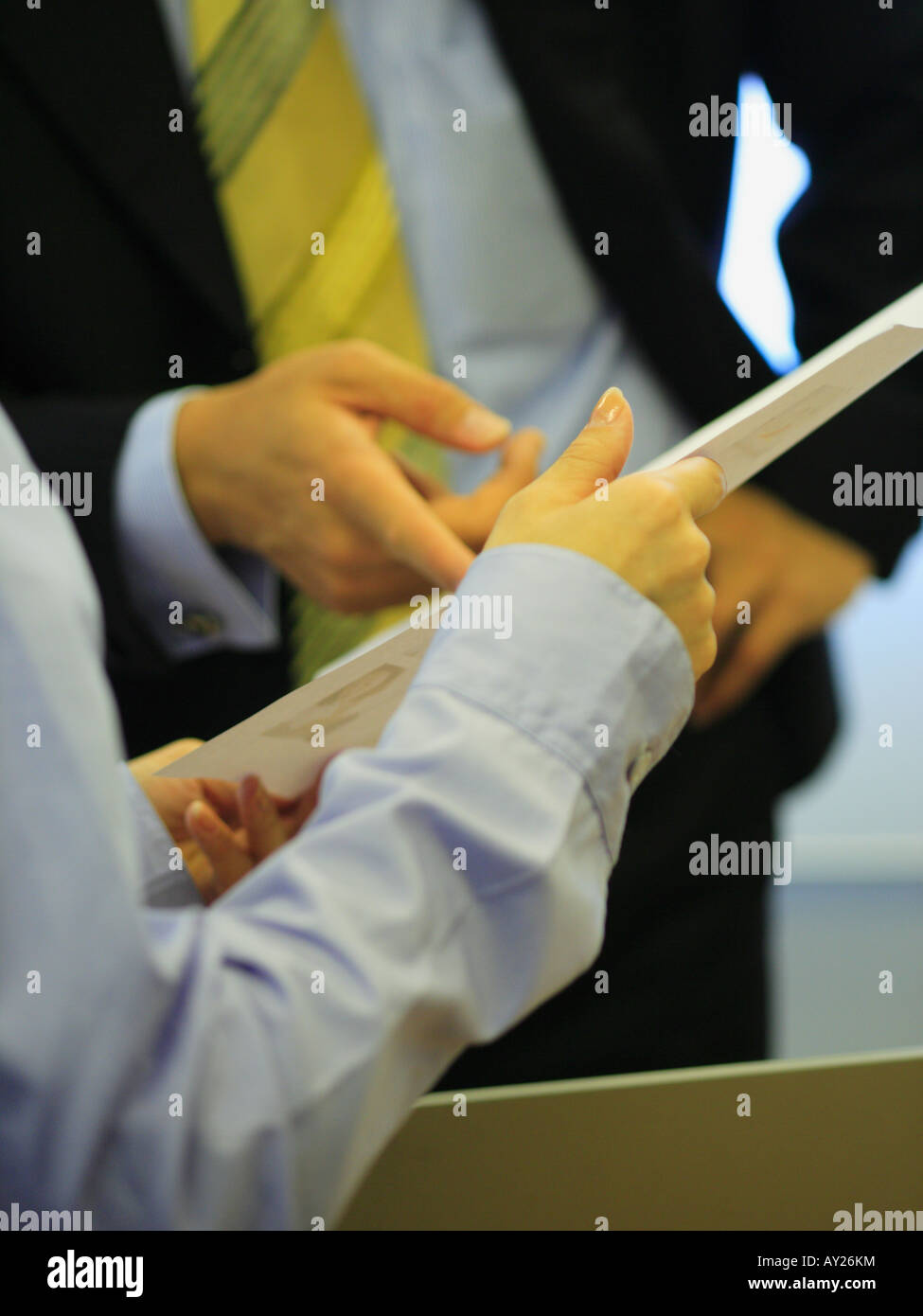 Businesswoman showing document businessman hi-res stock photography and ...
