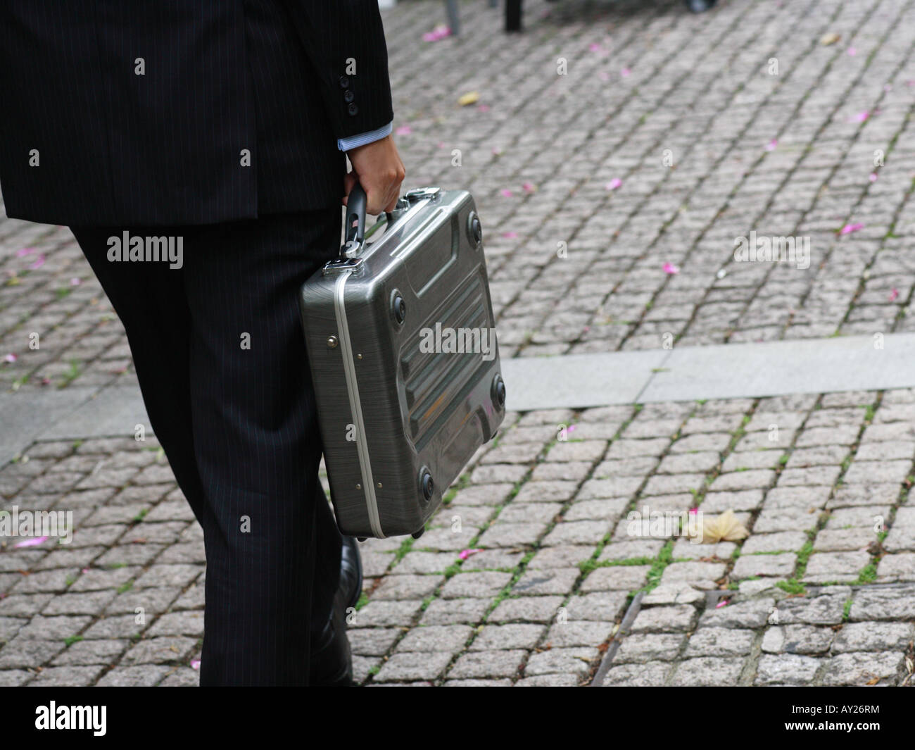 Low section view of a businessman carrying a briefcase Stock Photo - Alamy