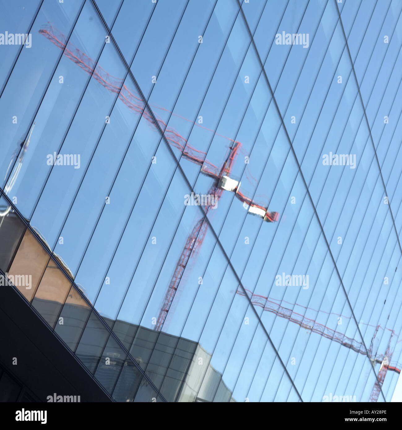Glass building with reflection of crane Stock Photo - Alamy