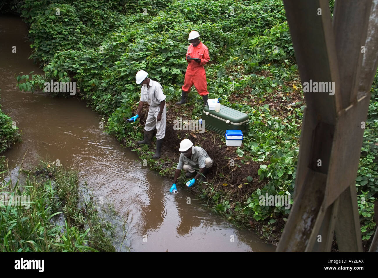 Taking water samples from river to test quality on industrial mining ...
