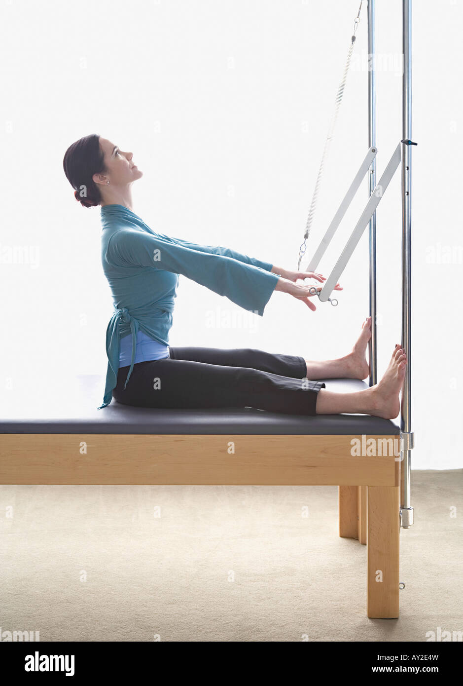 Woman stretching on exercise equipment Stock Photo - Alamy