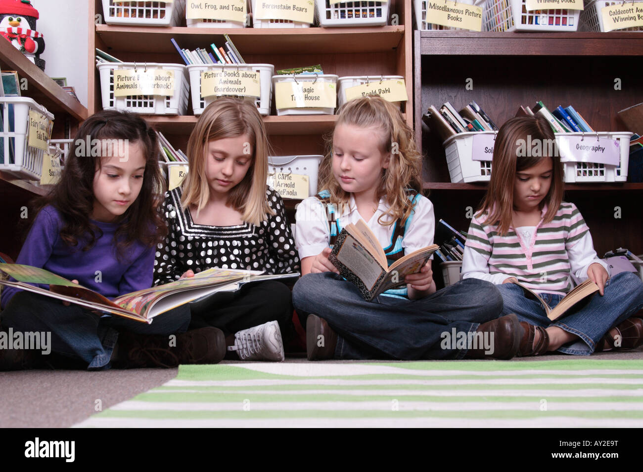 Stock Photograph of grade schoolers reading in the class library Stock ...