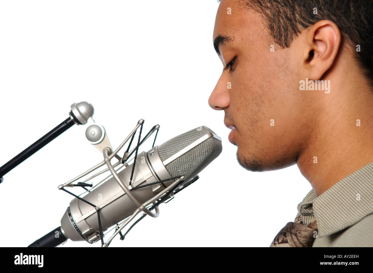 Young man singing into a vintage microphone Stock Photo - Alamy