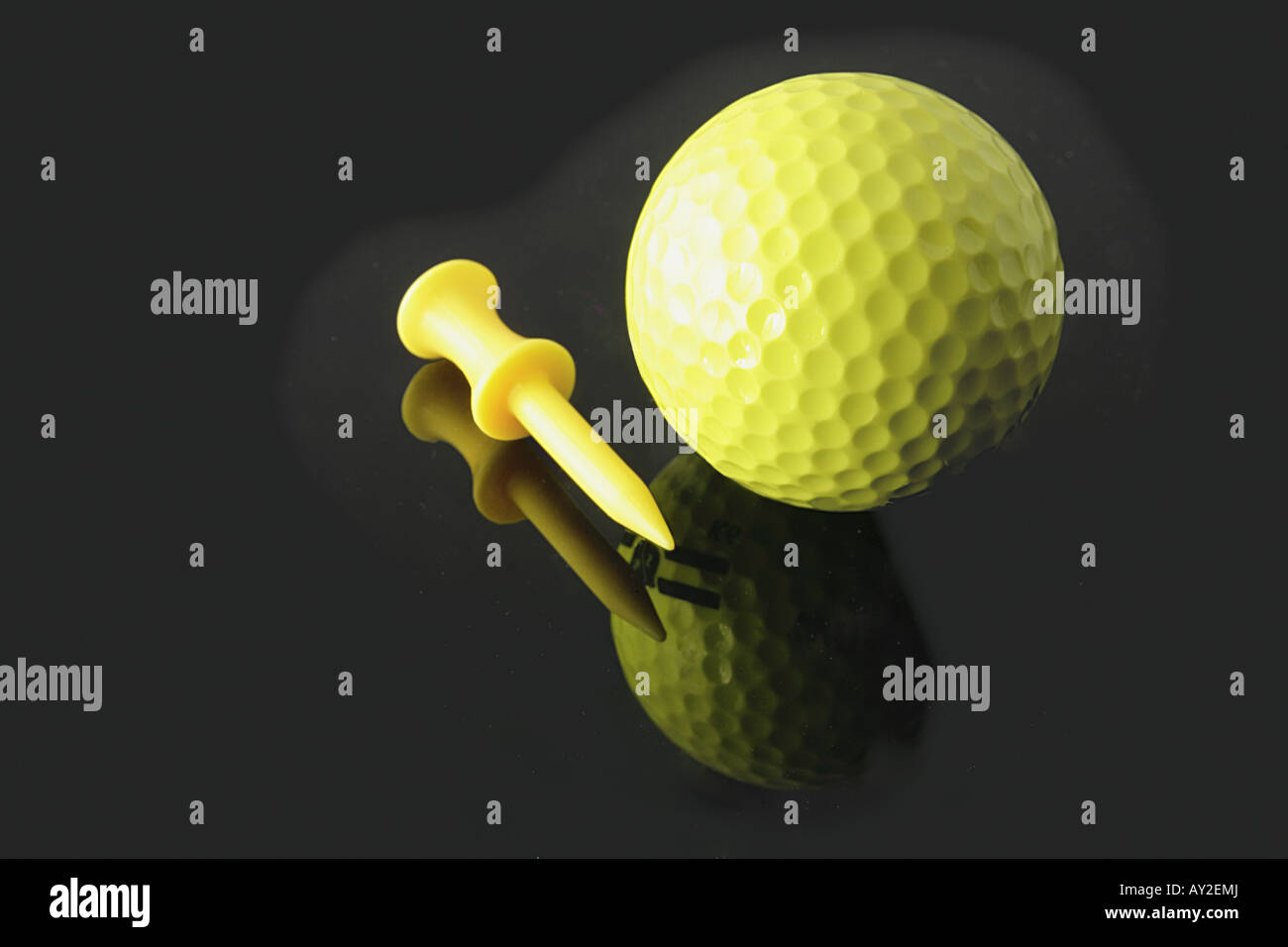 Yellow Golf Ball and Tee Stock Photo - Alamy