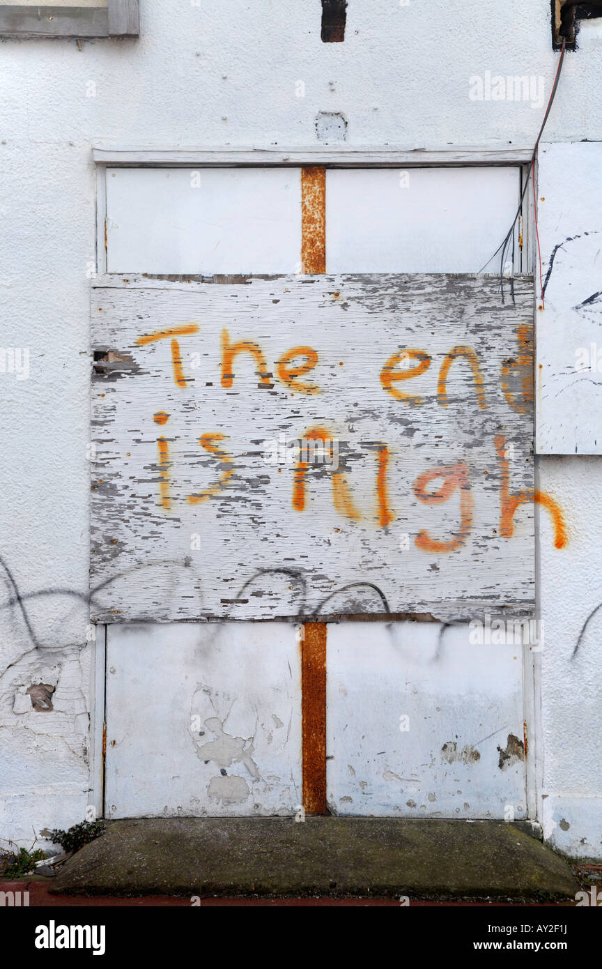 apocalyptic graffiti stating the end is nigh in yellow on a white ...