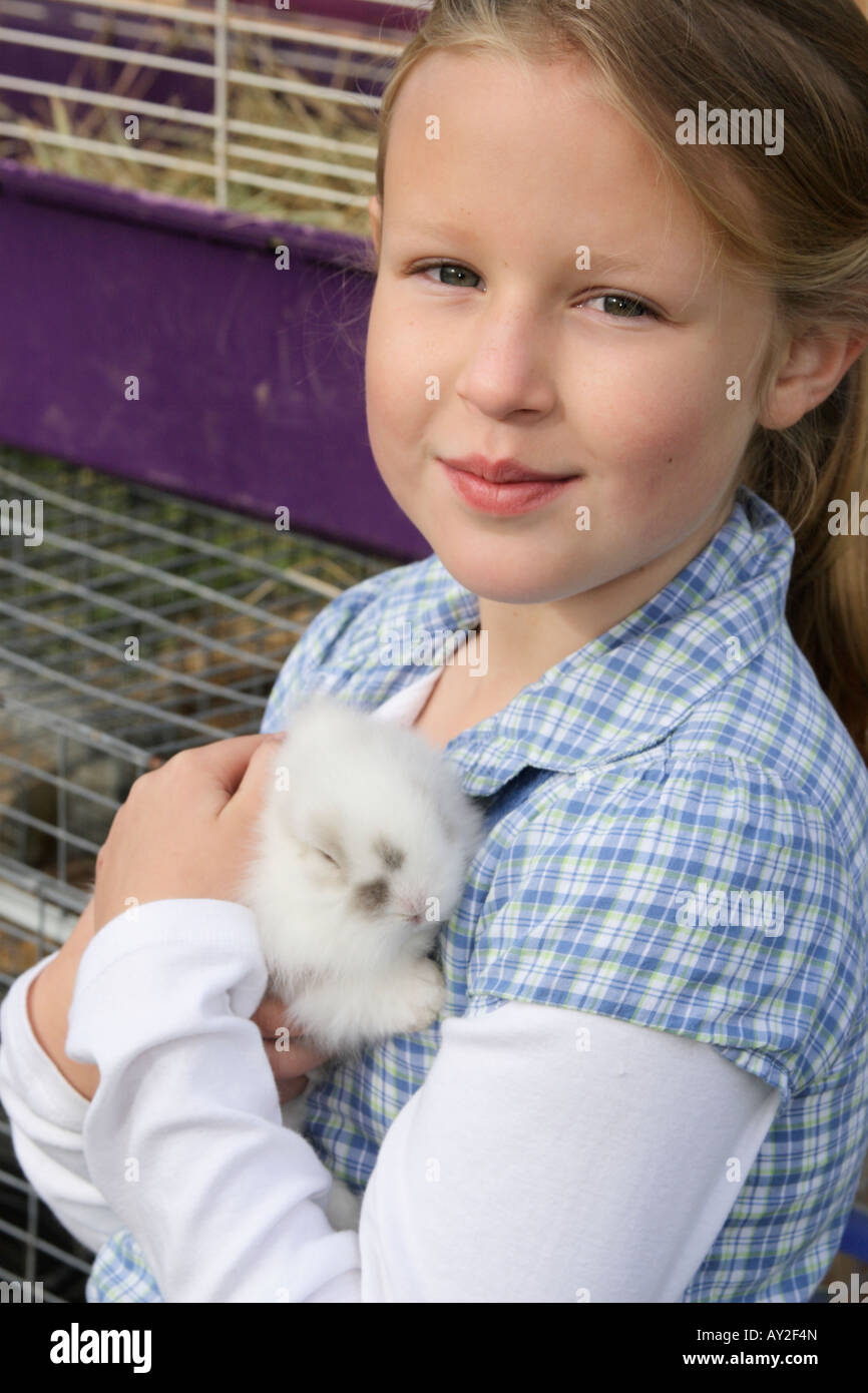 Stock Photograph of a young girl holding a rabbit Stock Photo - Alamy
