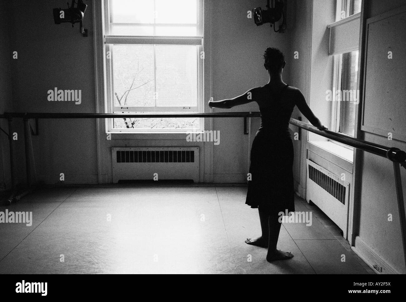 A ballerina does bar exercises in a dance studio Stock Photo - Alamy