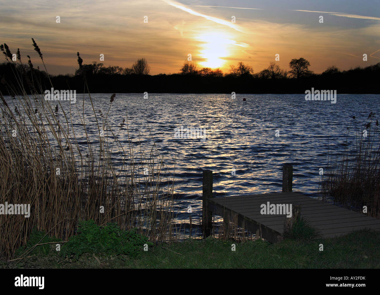 The sun setting over Kent lakes Stock Photo - Alamy