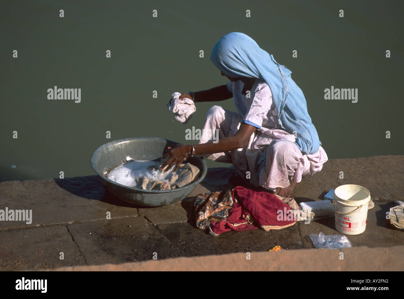 Indian woman washing clothes outside hi-res stock photography and ...