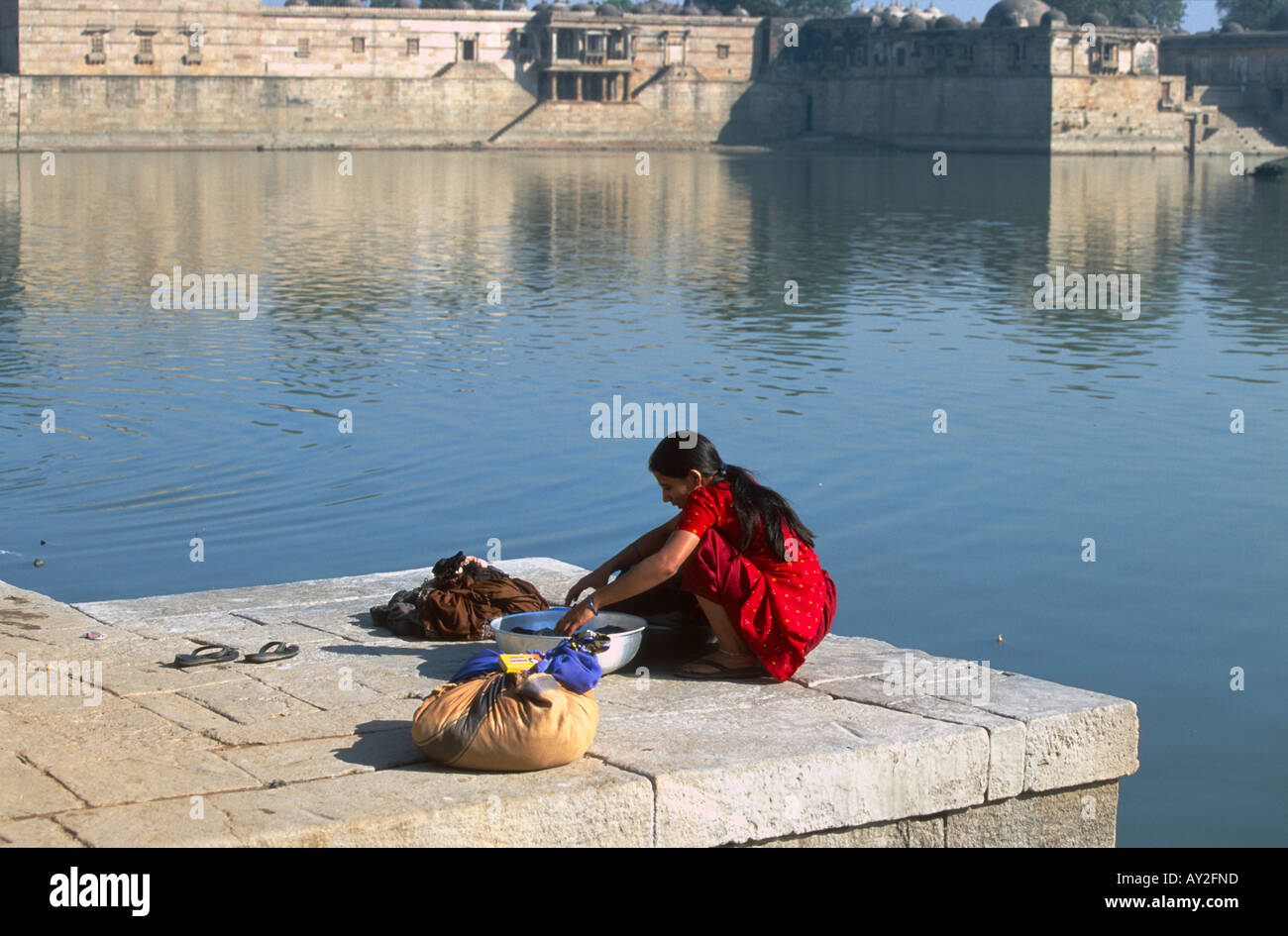 Indian woman washing clothes outside hi-res stock photography and ...