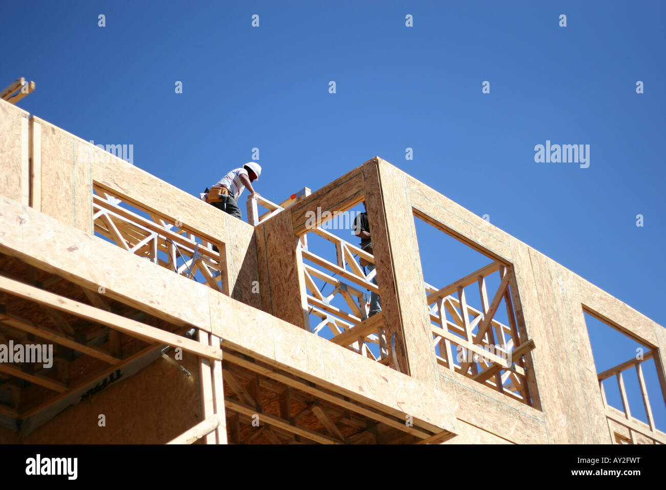 Carpenters working on wood frame condominium complex Stock Photo - Alamy