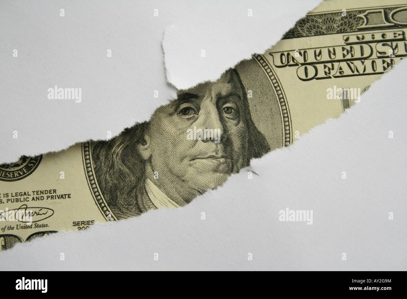 Large hole in the white paper and one hundred dollar bill in it Stock ...