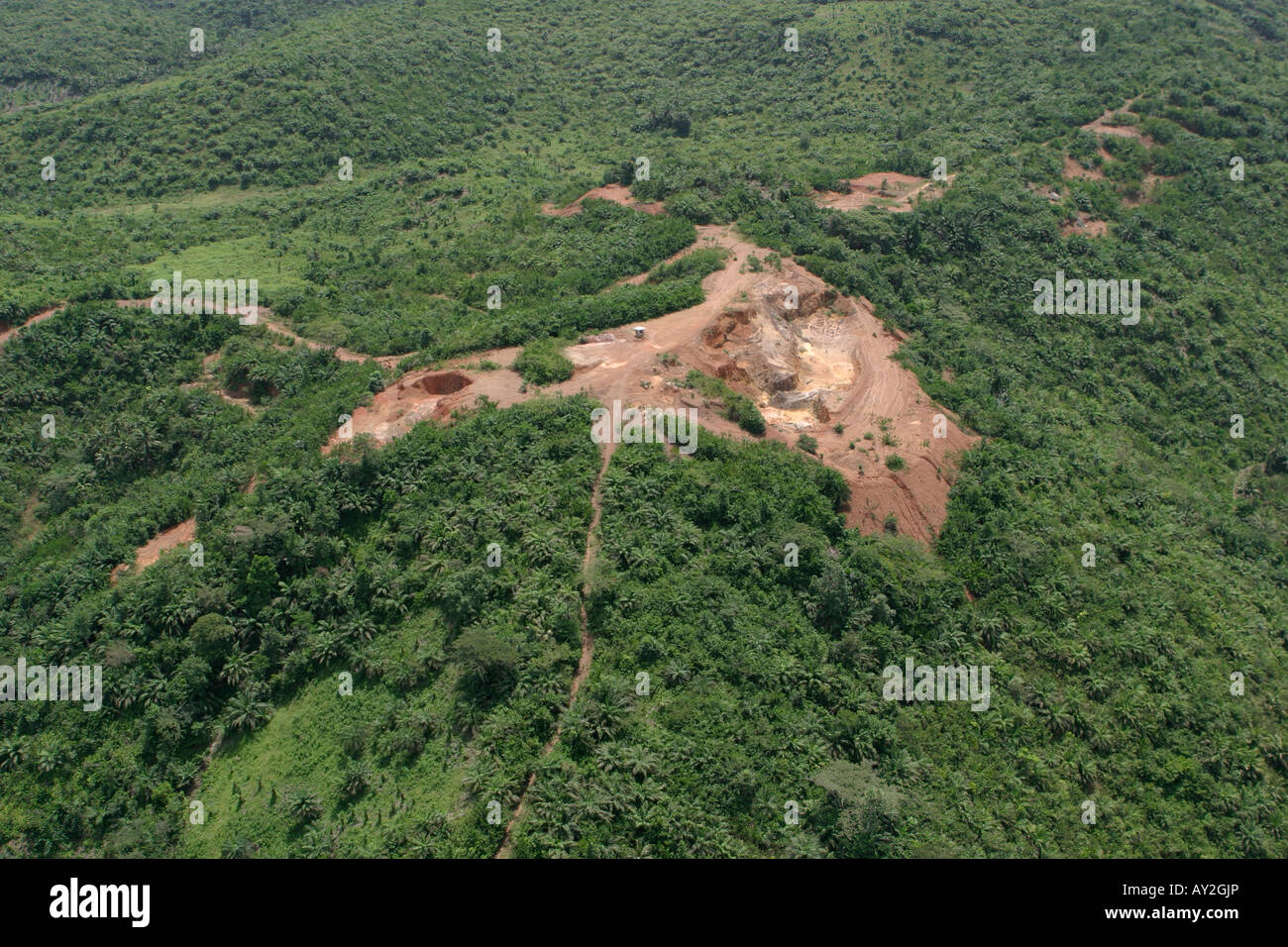 Aerial of old open cast pit on hill top belonging to small scale ...