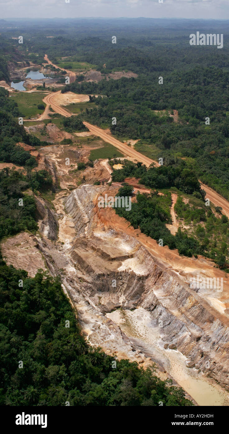 Aerial view looking along African gold mining concession with old pits ...