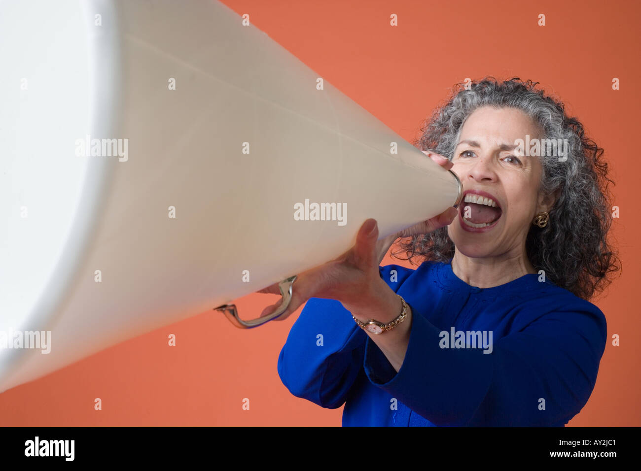 Portrait Caucasian woman yelling through megaphone Stock Photo - Alamy