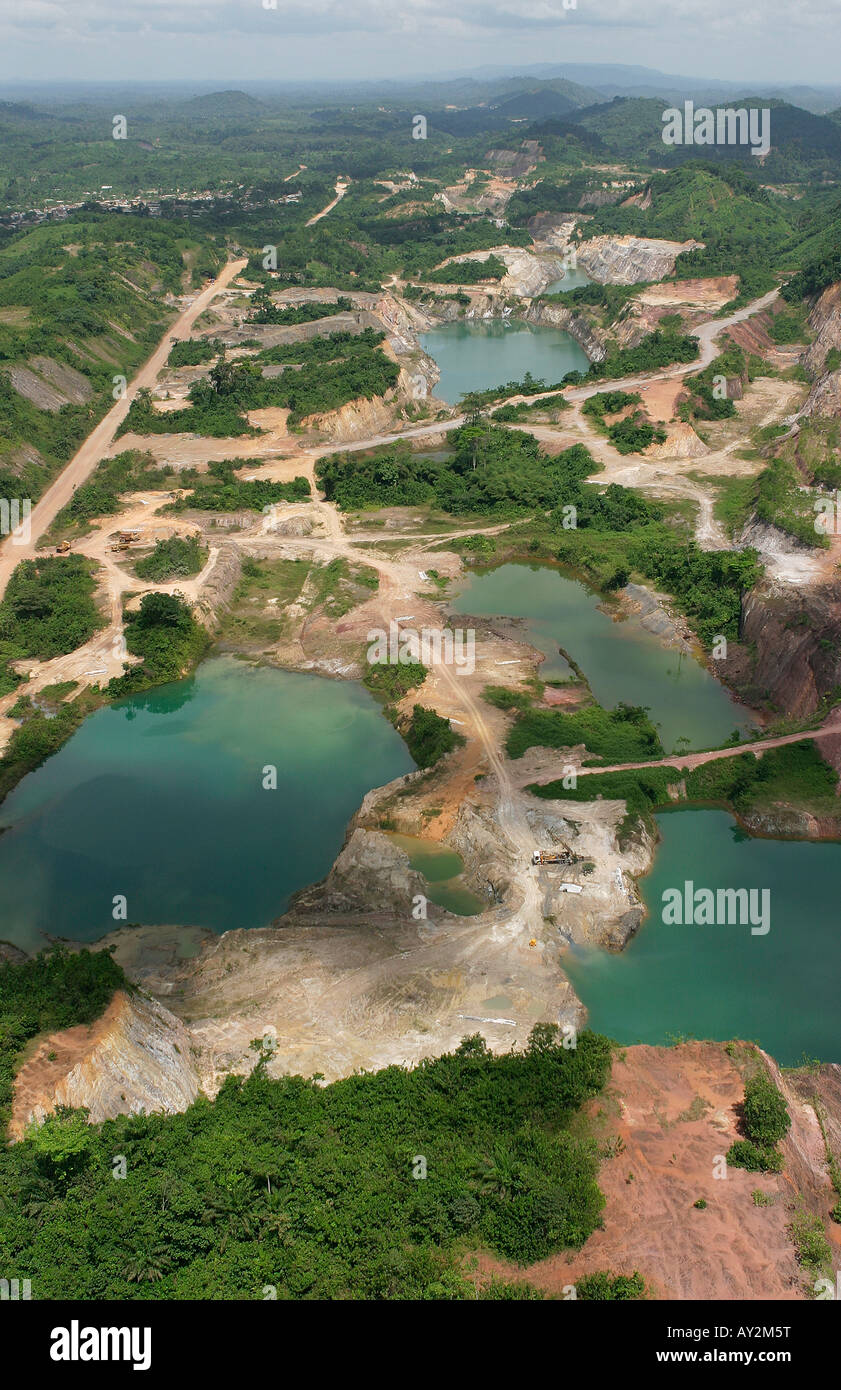 Aerial view looking along African gold mining concession with old pits ...