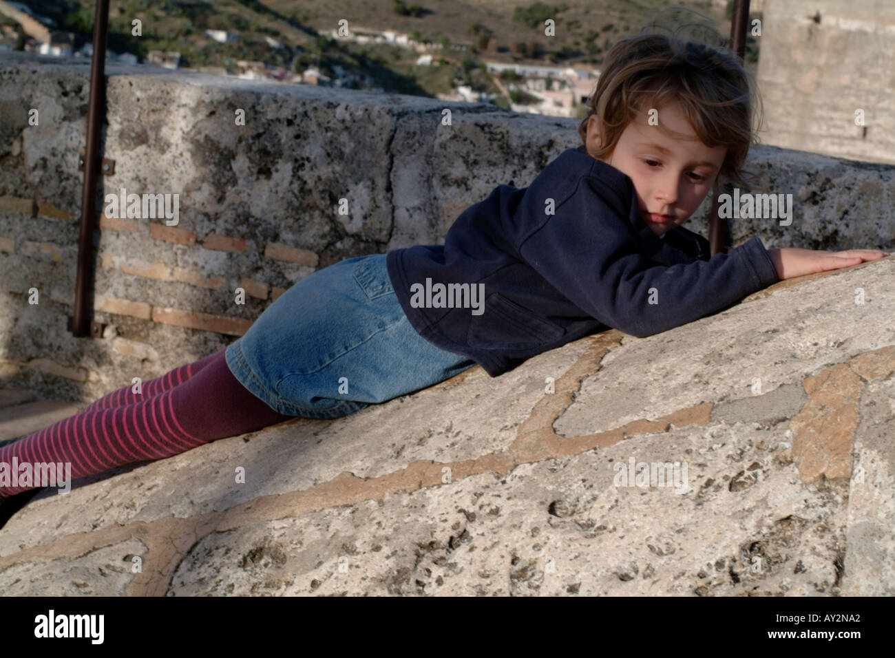 Little girl scaling a wall Stock Photo - Alamy