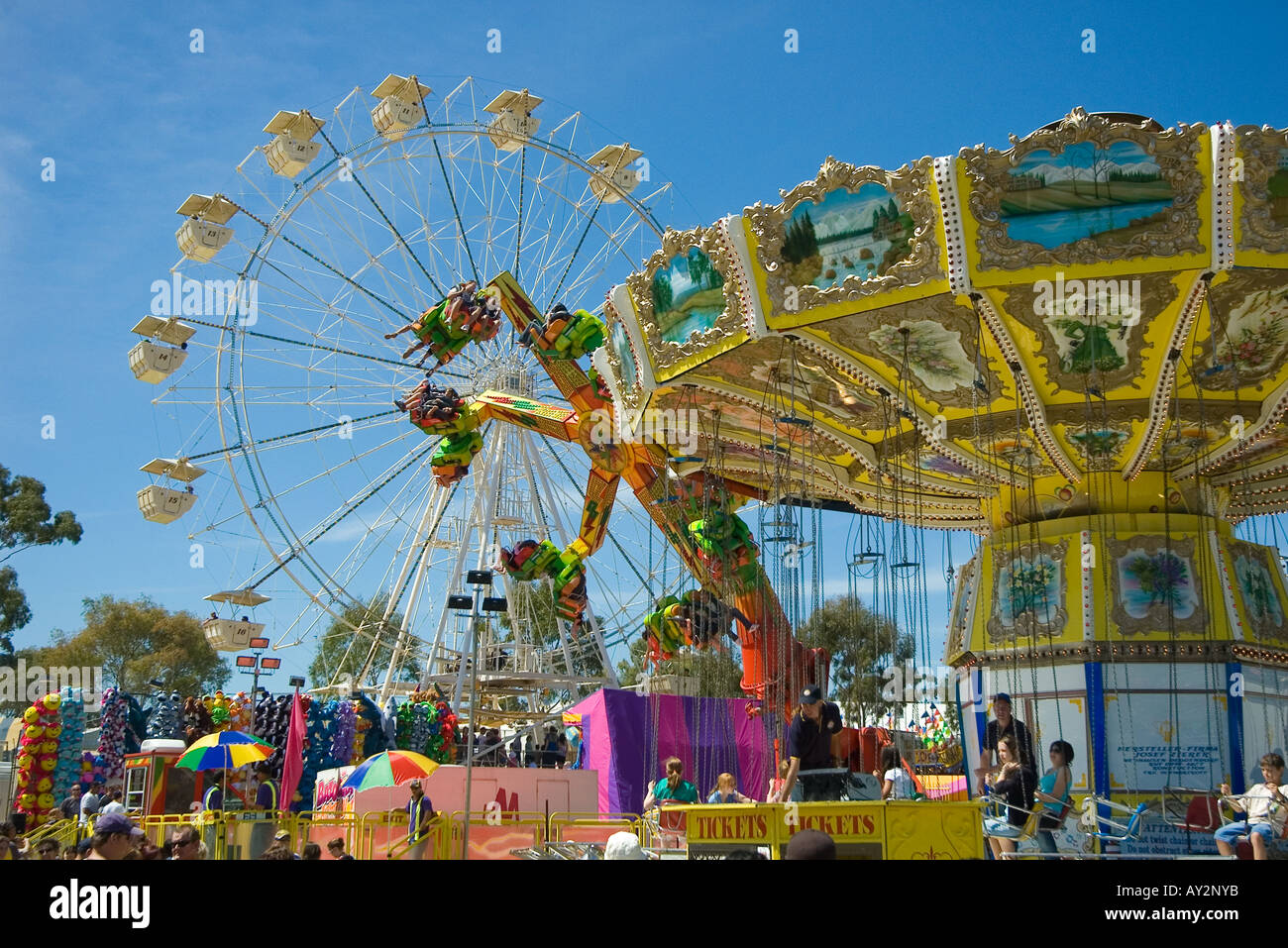 Crowds enjoying funfair rides in the sunshine, Royal Agricultural Show ...