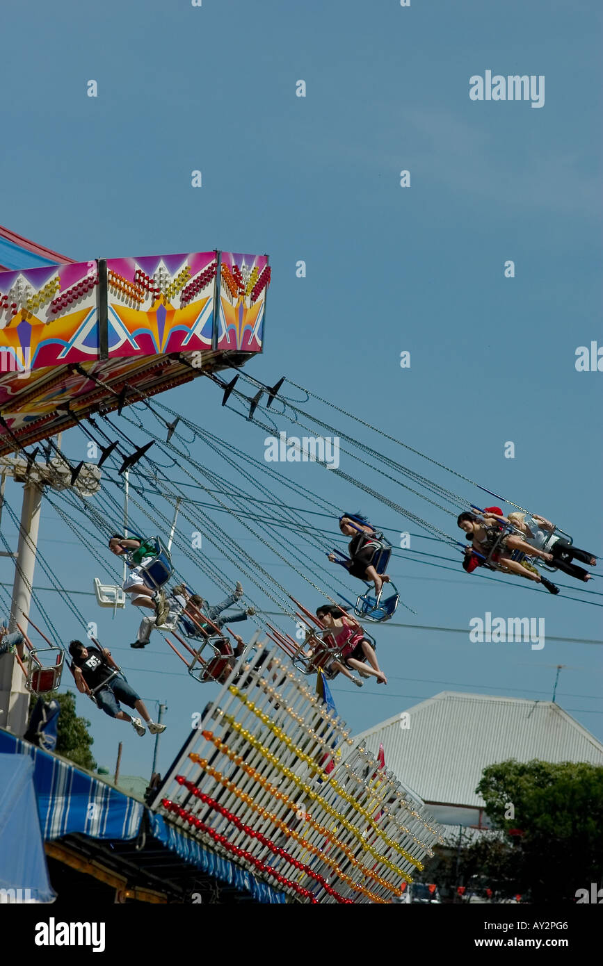 Crowds enjoying funfair rides in the sunshine, Royal Agricultural Show ...