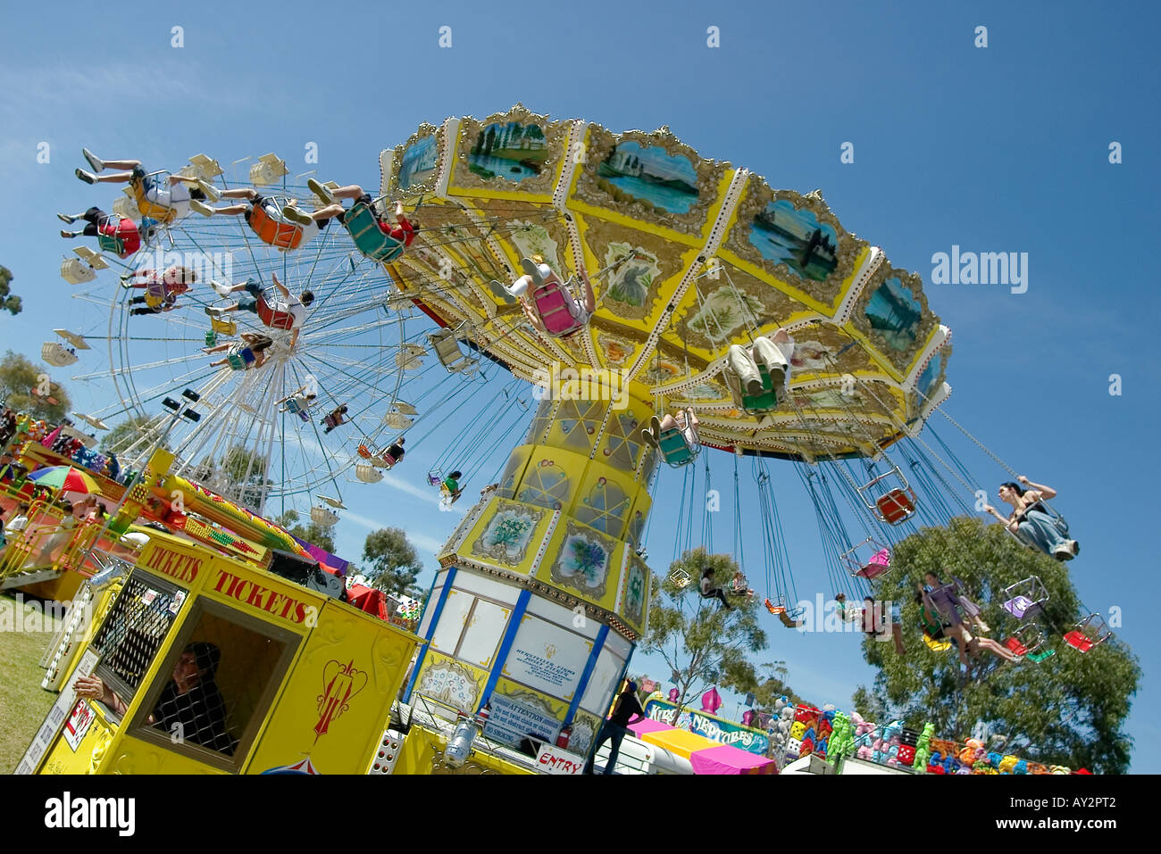 Crowds enjoying funfair rides in the sunshine, Royal Agricultural Show ...