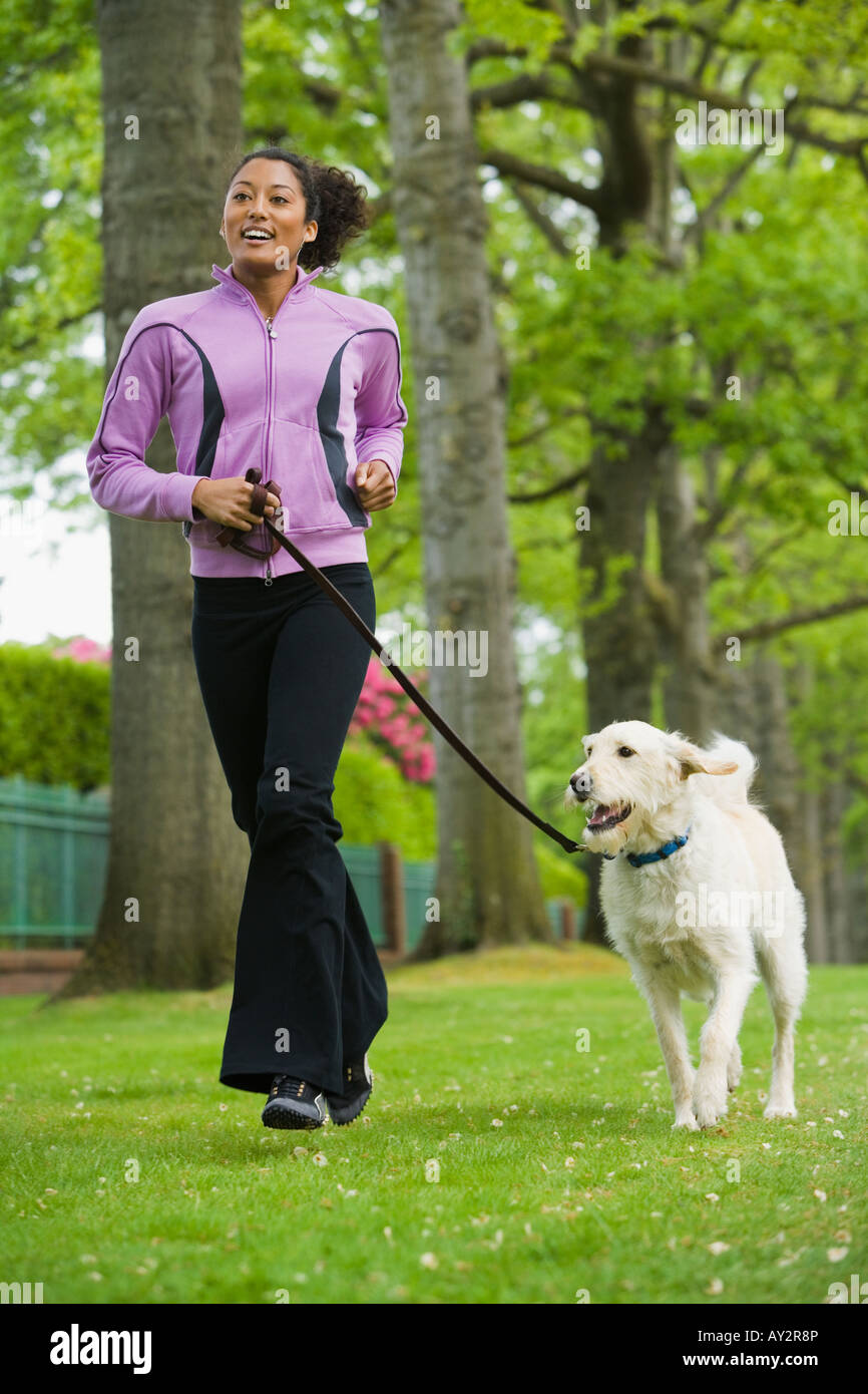 African American woman jogging with dog Stock Photo - Alamy