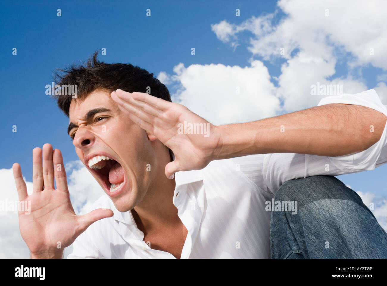 Man yelling with hands up Stock Photo - Alamy