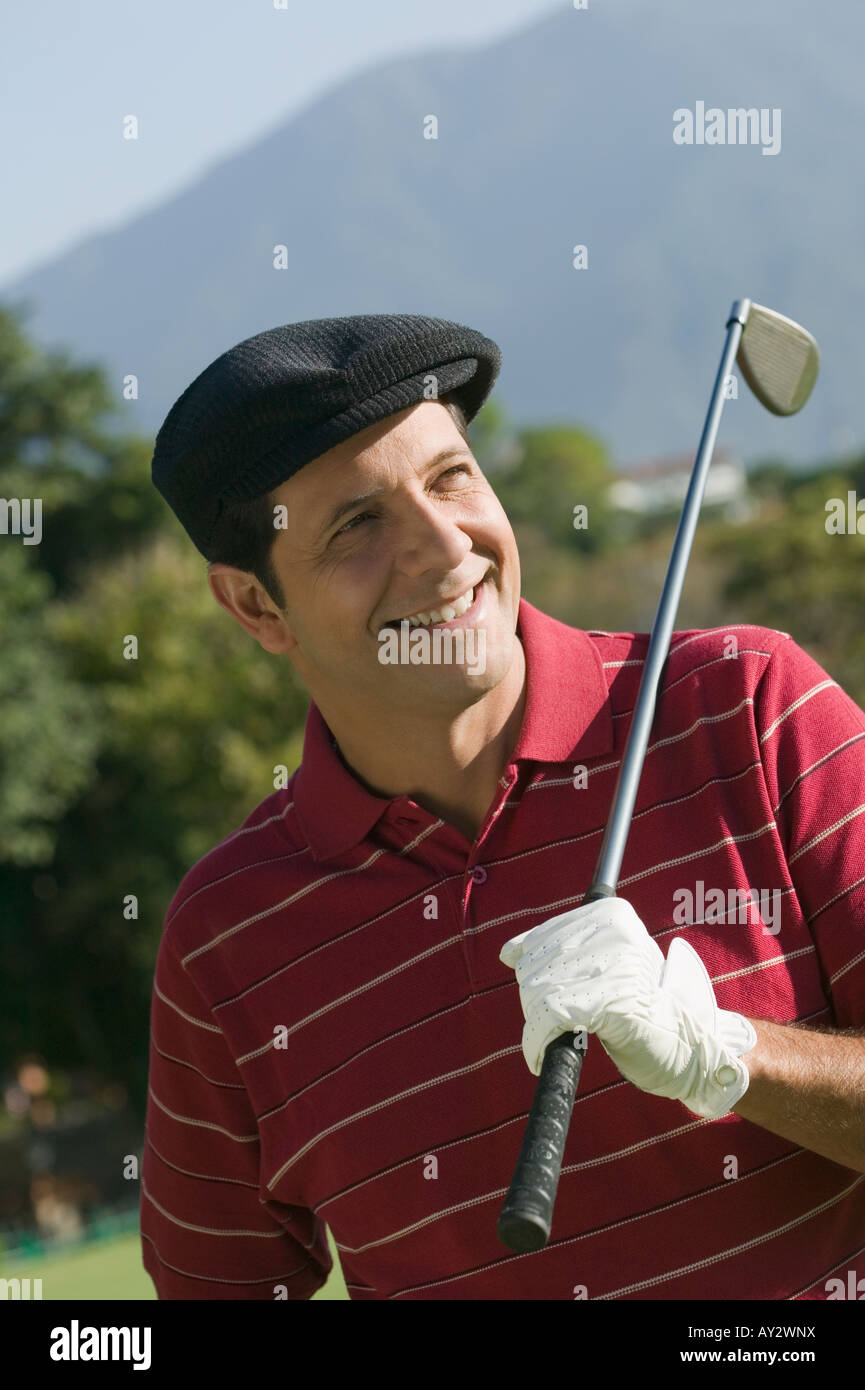 Hispanic man holding golf club over shoulder Stock Photo - Alamy