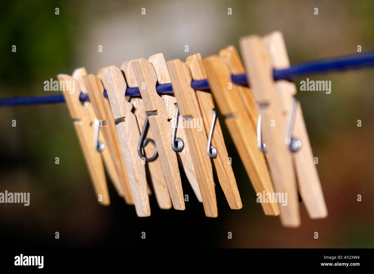 Wooden clothes pegs on a washing line Stock Photo - Alamy