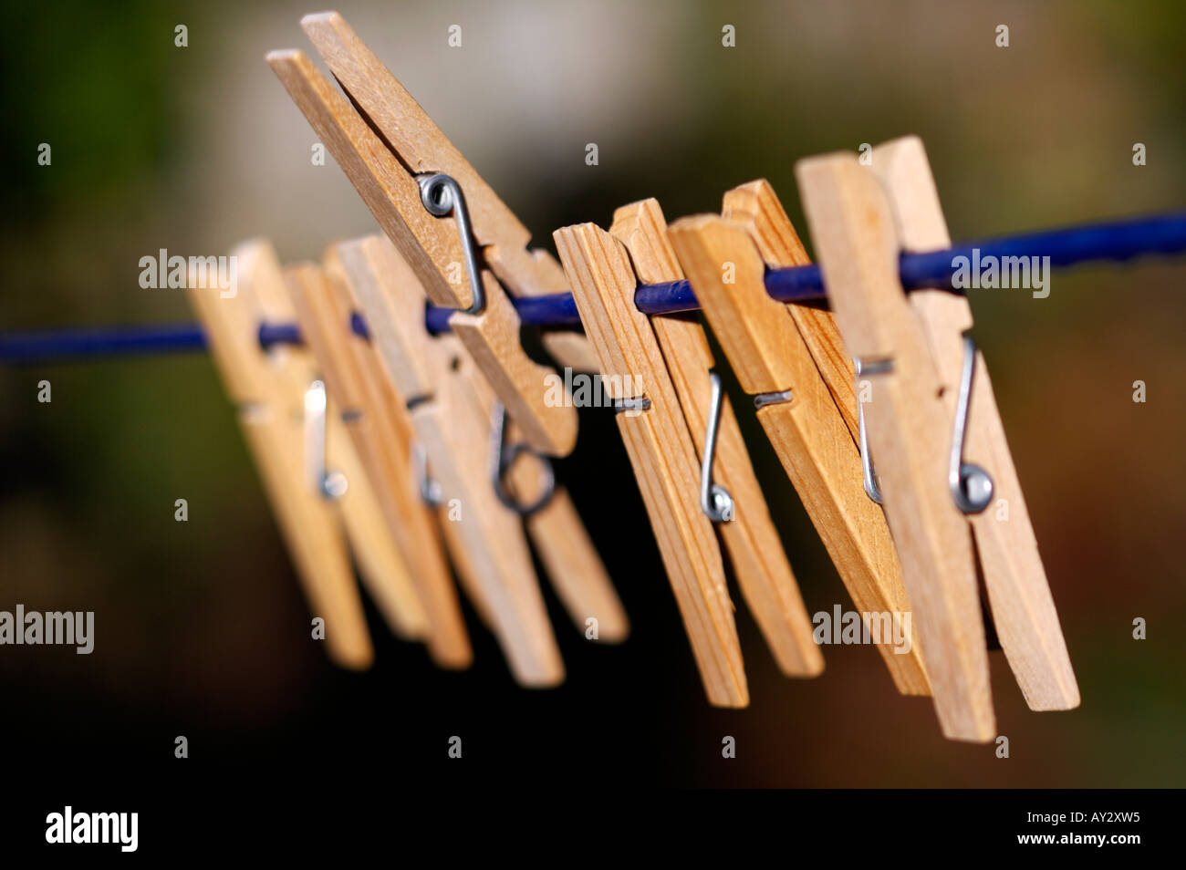 Wooden clothes pegs on a washing line Stock Photo - Alamy