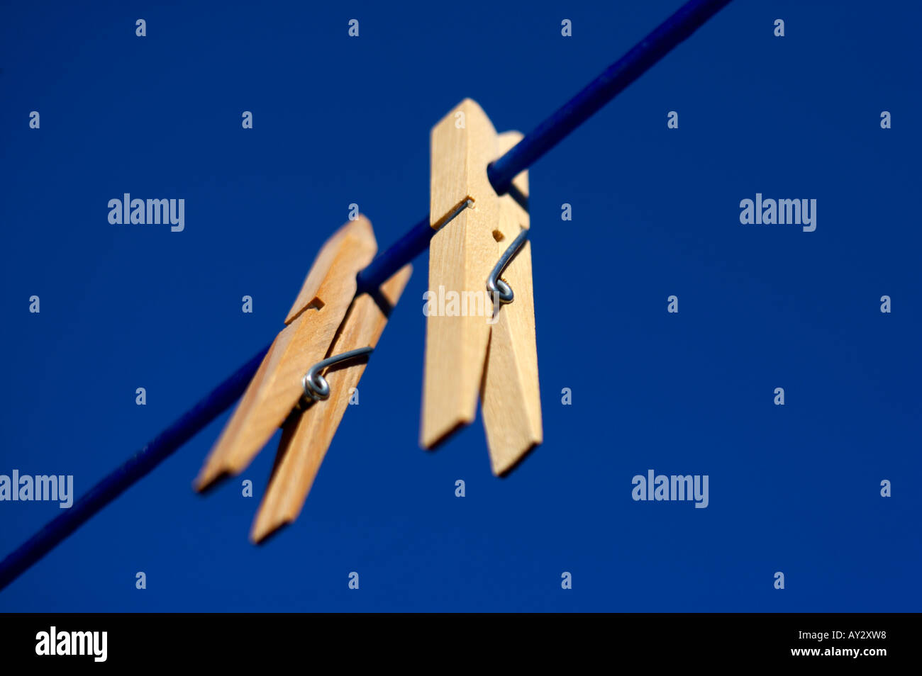 Wooden clothes pegs on a washing line Stock Photo - Alamy