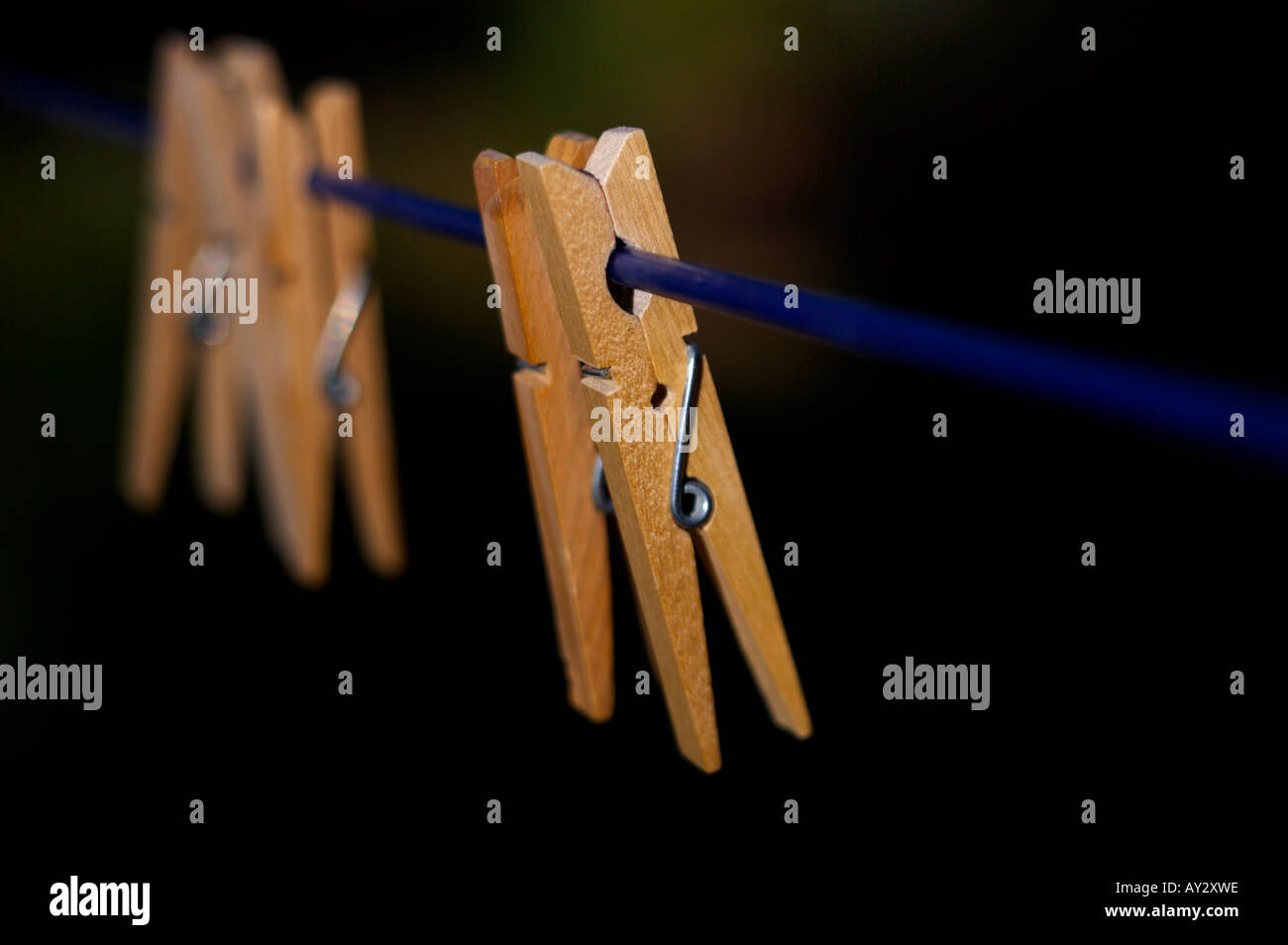 Wooden clothes pegs on a washing line Stock Photo - Alamy