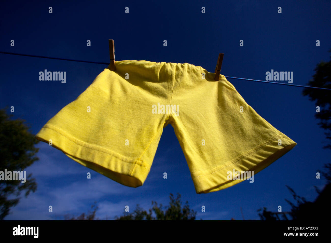 Yellow shorts on a washing line Stock Photo - Alamy
